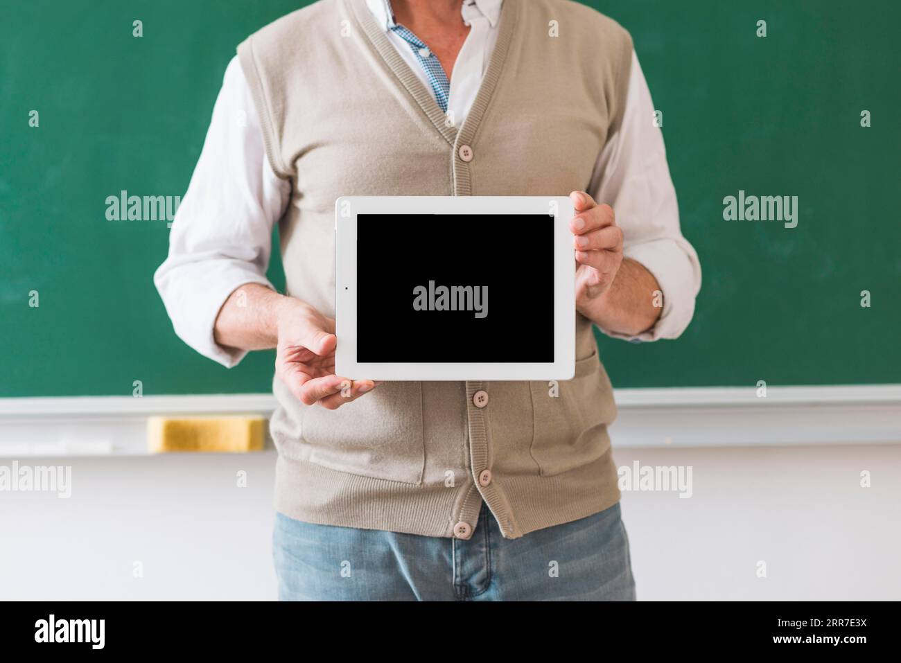 Professor holding tablet with blank space classroom Stock Photo - Alamy