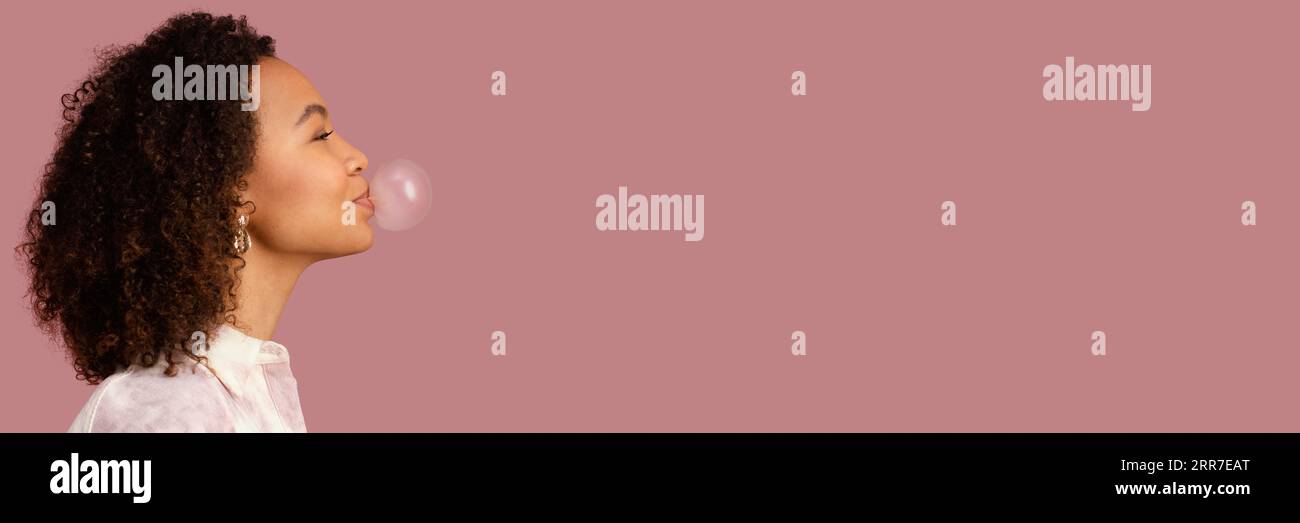 Side view smiley woman with chewing gum Stock Photo - Alamy