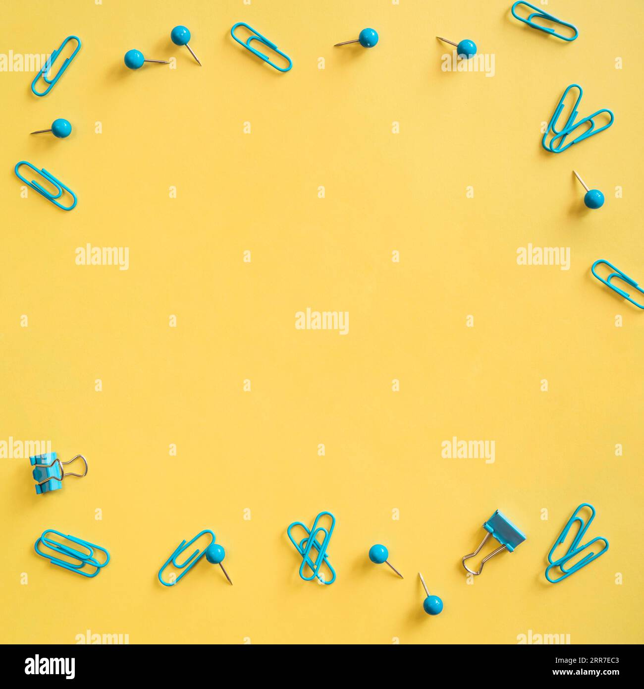 Small blue paper fasteners Stock Photo - Alamy