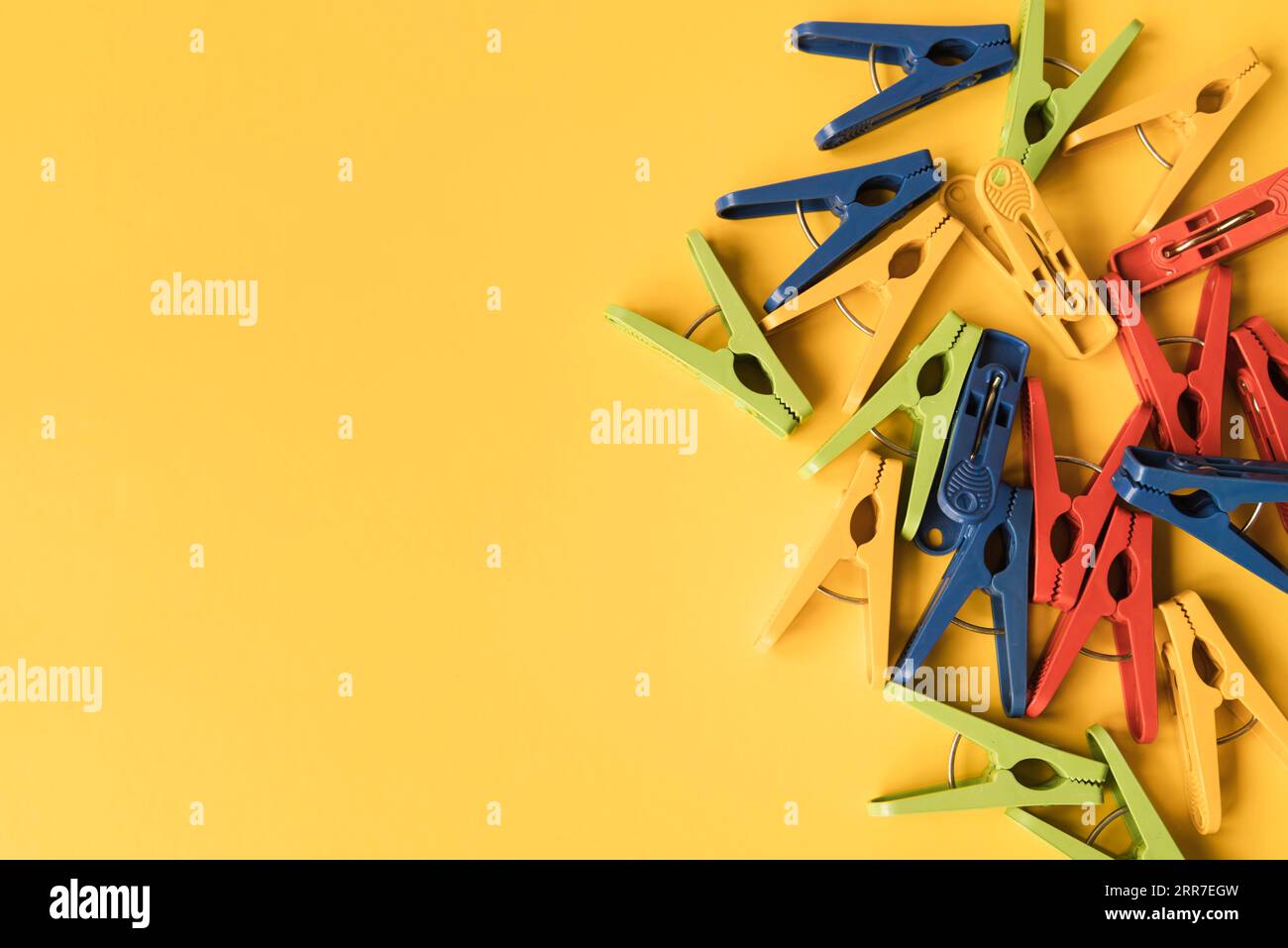 Top view clothespin with yellow background Stock Photo - Alamy