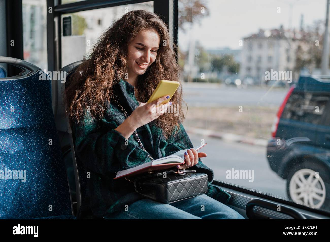 Woman with curly hair travelling with bus Stock Photo - Alamy