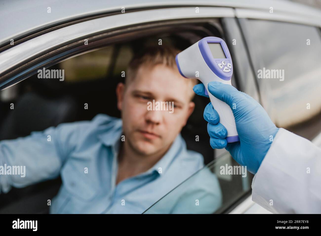 Adult male getting his temperature checked Stock Photo - Alamy
