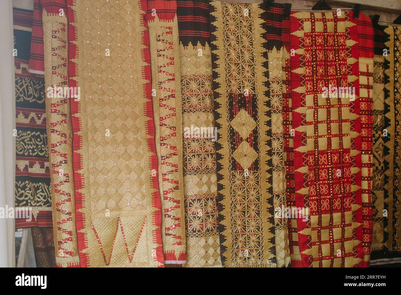 Fabric Various motifs. different fabrics displayed on the shelves. a ...