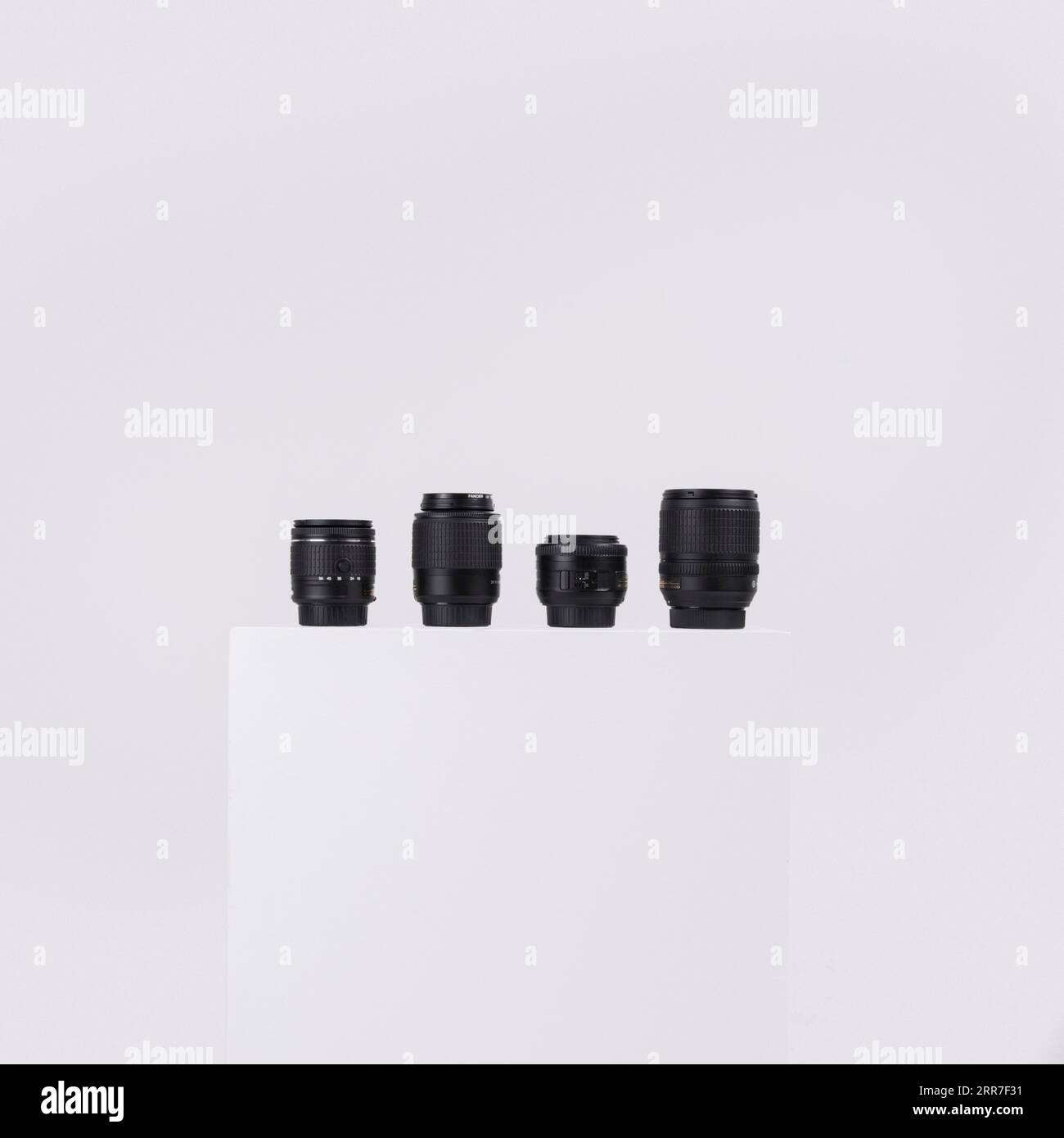 Camera lenses arranged white block against isolated white background ...