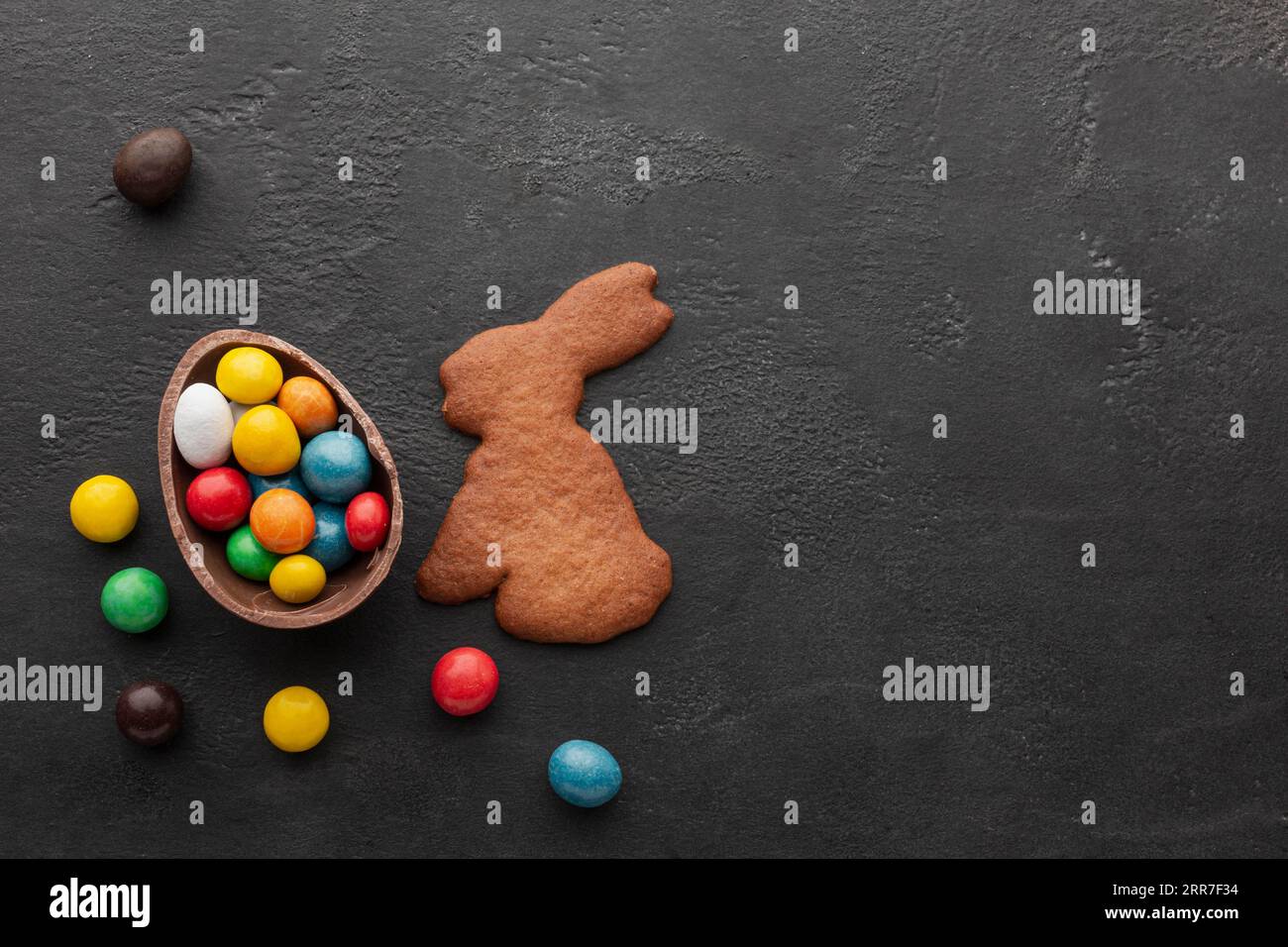 Chocolate easter egg filled with colorful candy bunny shaped cookie ...