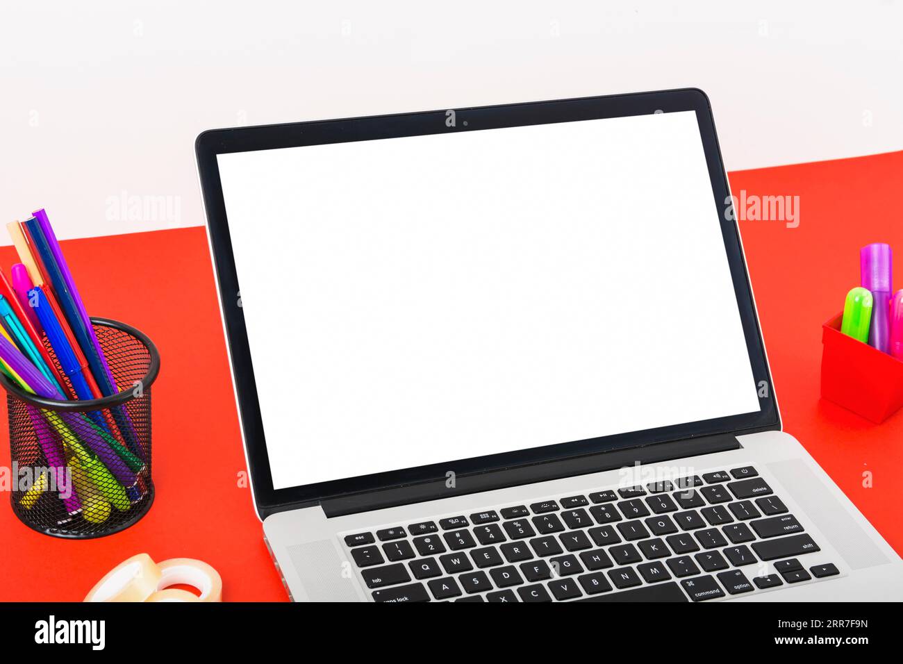 Close up modern laptop with blank white screen red table Stock Photo ...