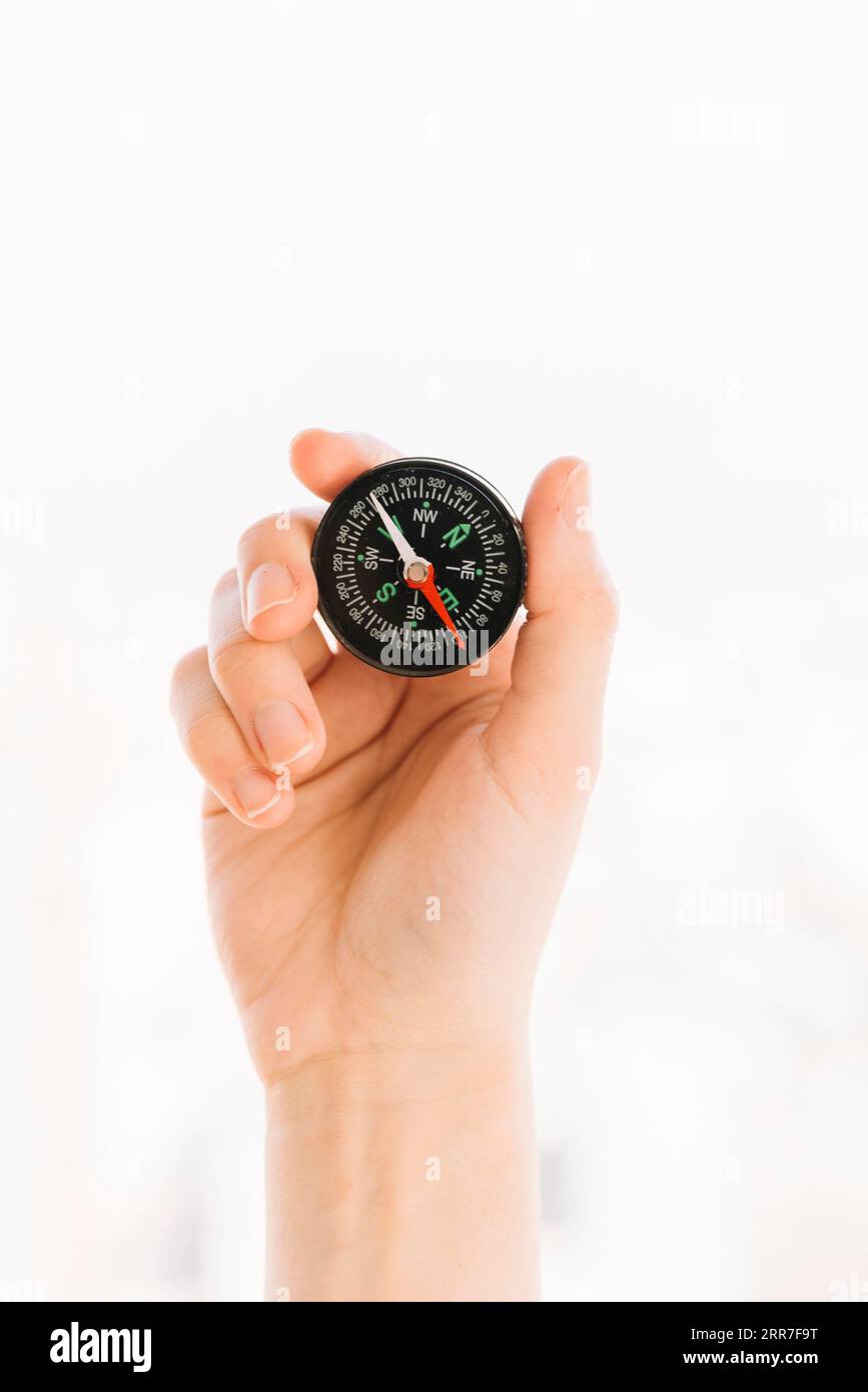 Close up person s hand holding compass isolated white background Stock ...