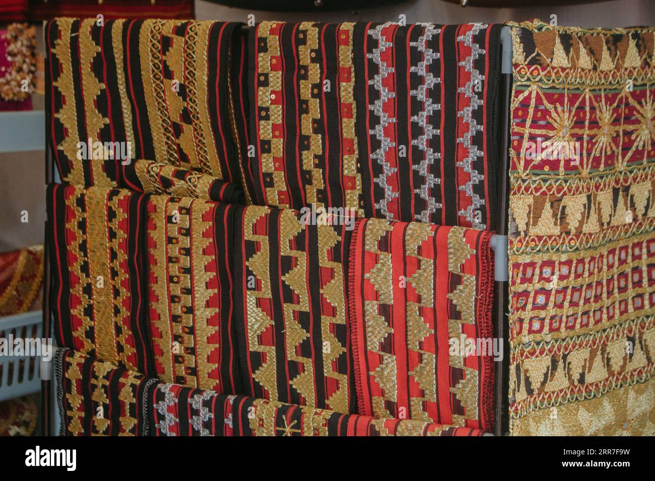 Fabric Various motifs. different fabrics displayed on the shelves. a ...