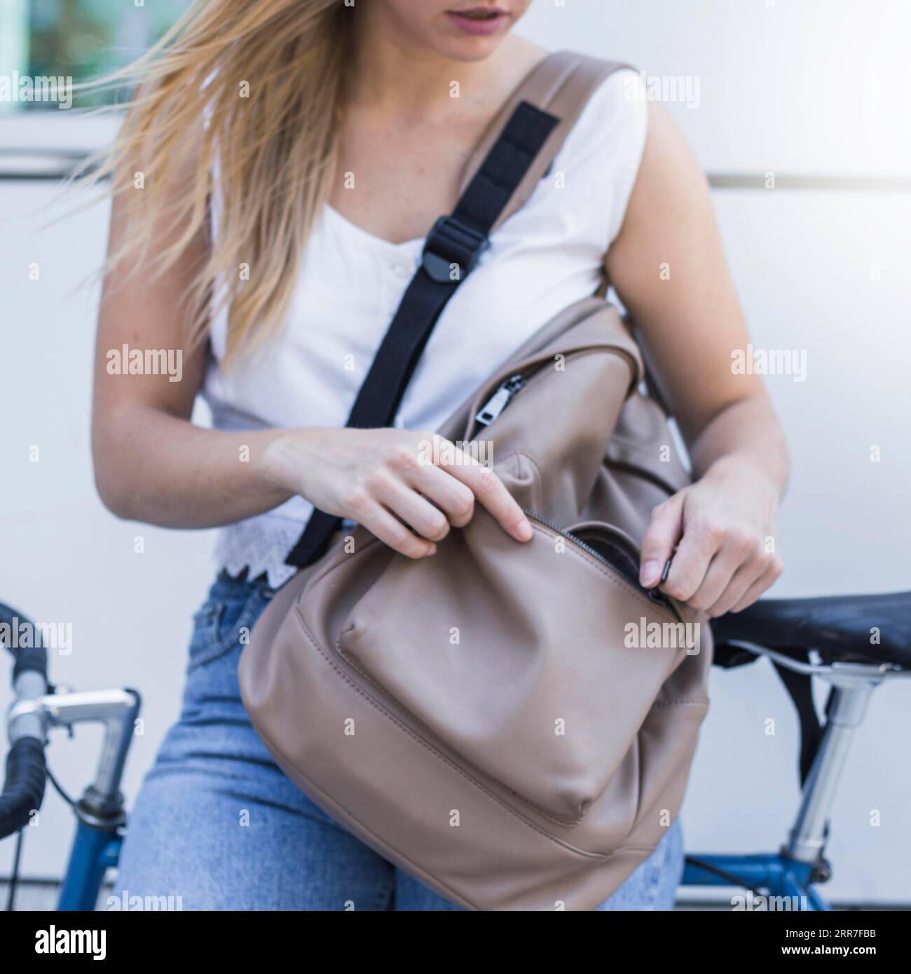 Close up young woman closing backpack zip Stock Photo - Alamy
