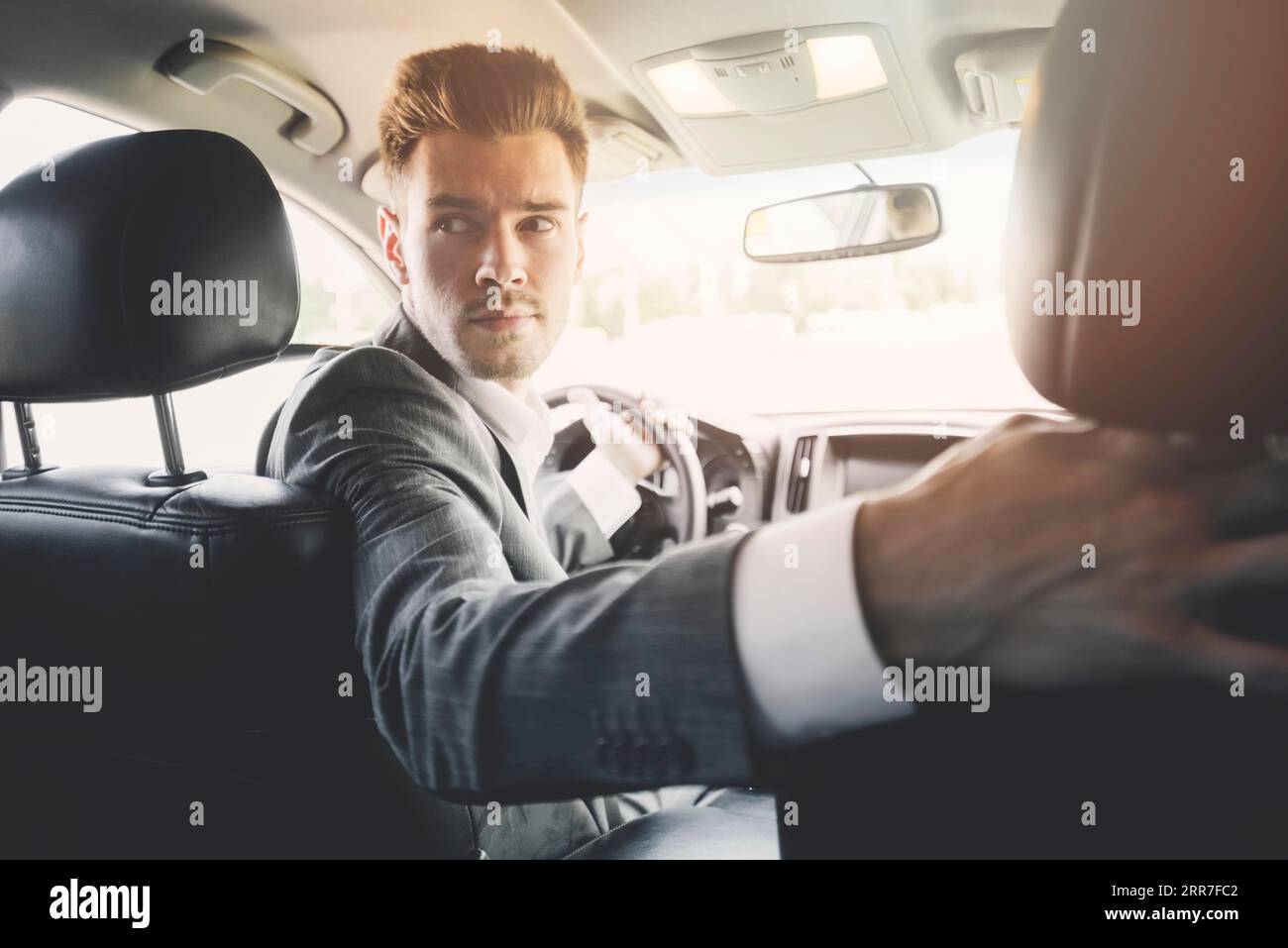 Close up handsome man driving reverse Stock Photo - Alamy