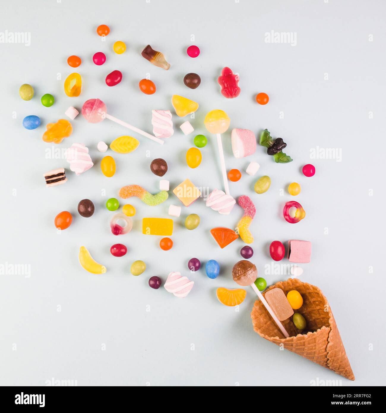 Elevated view various candies with ice cream waffle cone white ...