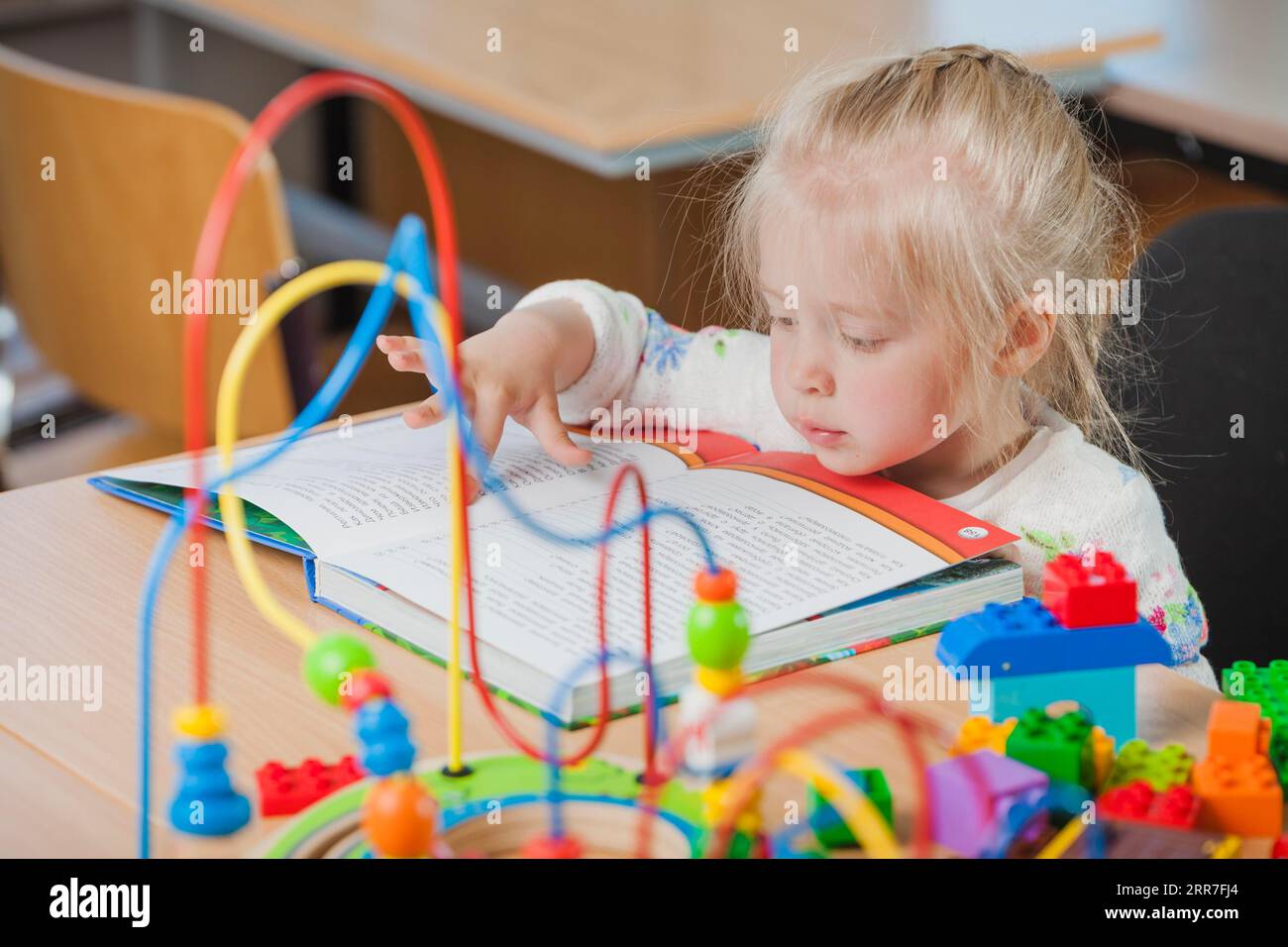 Cute toddler reading book Stock Photo - Alamy