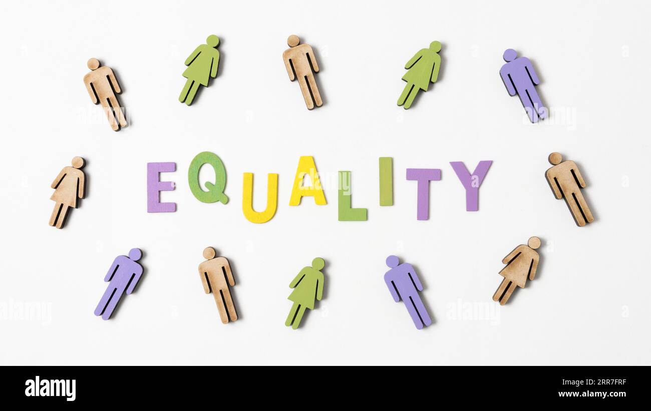 Equality lettering with people surroundings Stock Photo - Alamy