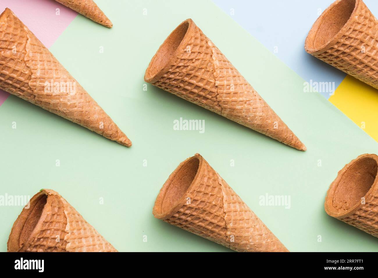 Empty ice cream waffle cones colourful background Stock Photo - Alamy