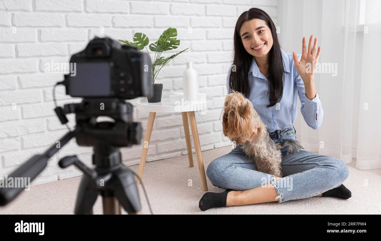 Female influencer home vlogging with dog Stock Photo - Alamy
