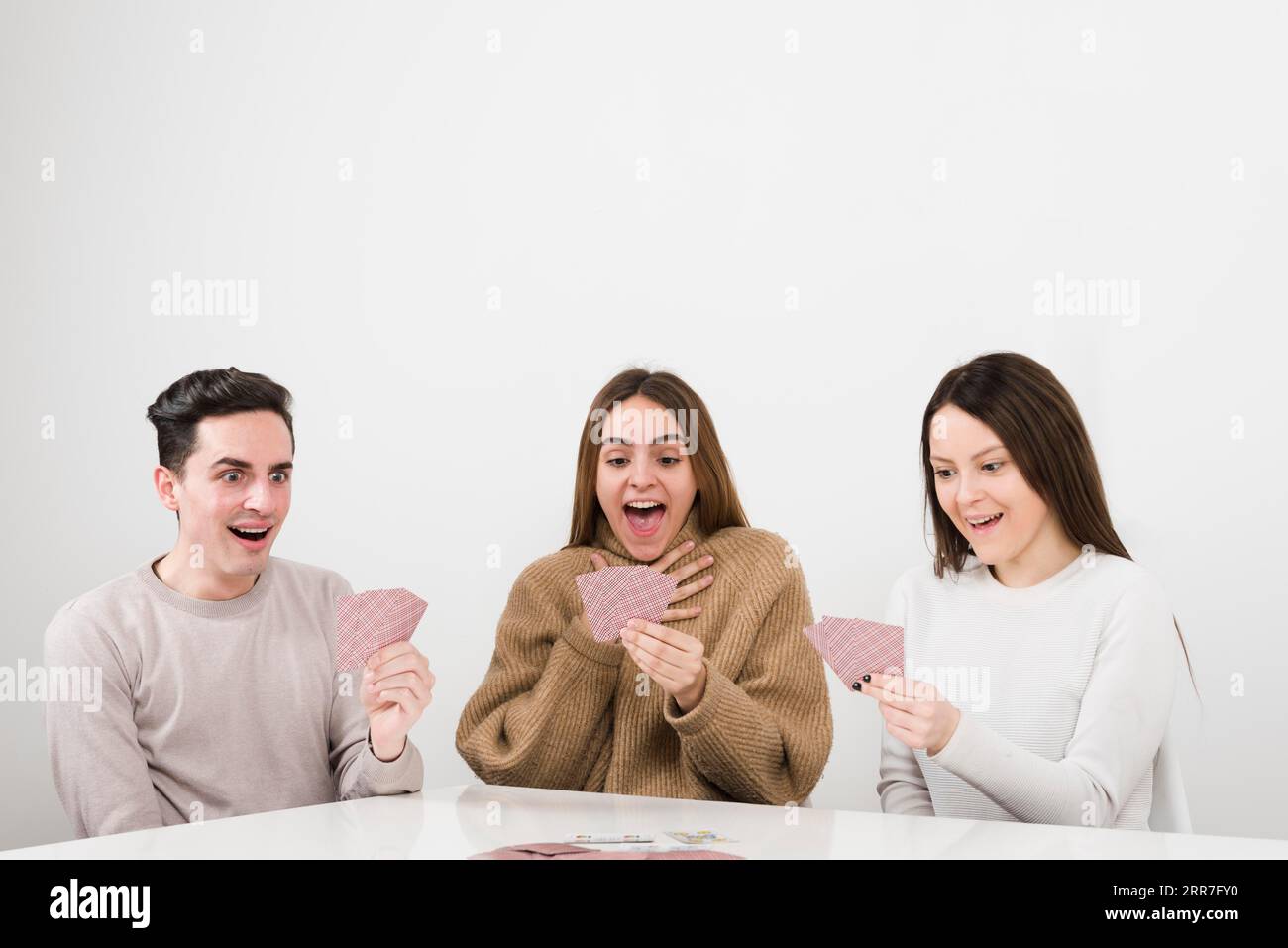 Three friends playing cards hi-res stock photography and images - Alamy