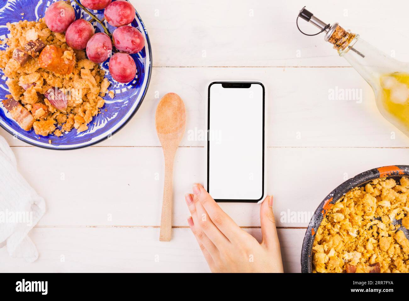 Food plates hand with mobile phone cooking table Stock Photo - Alamy