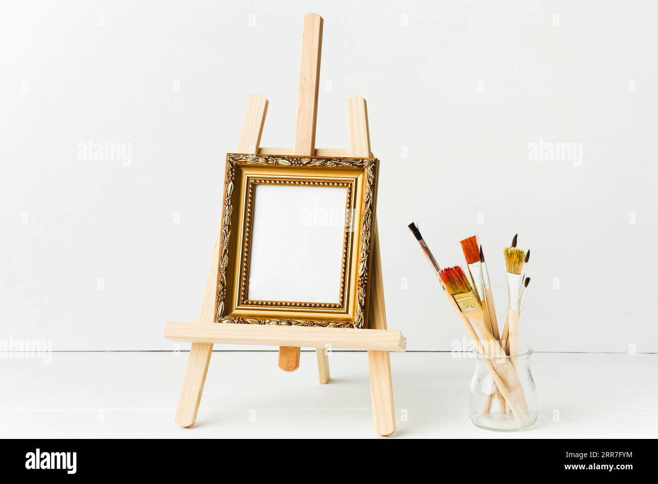 Front view minimalist frame easel brushes Stock Photo - Alamy