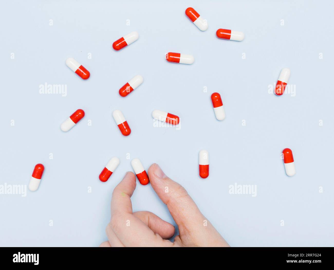 Hand picking capsule top view Stock Photo - Alamy