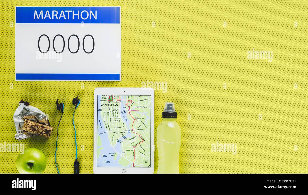 Healthy food near tablet marathon supplies Stock Photo - Alamy