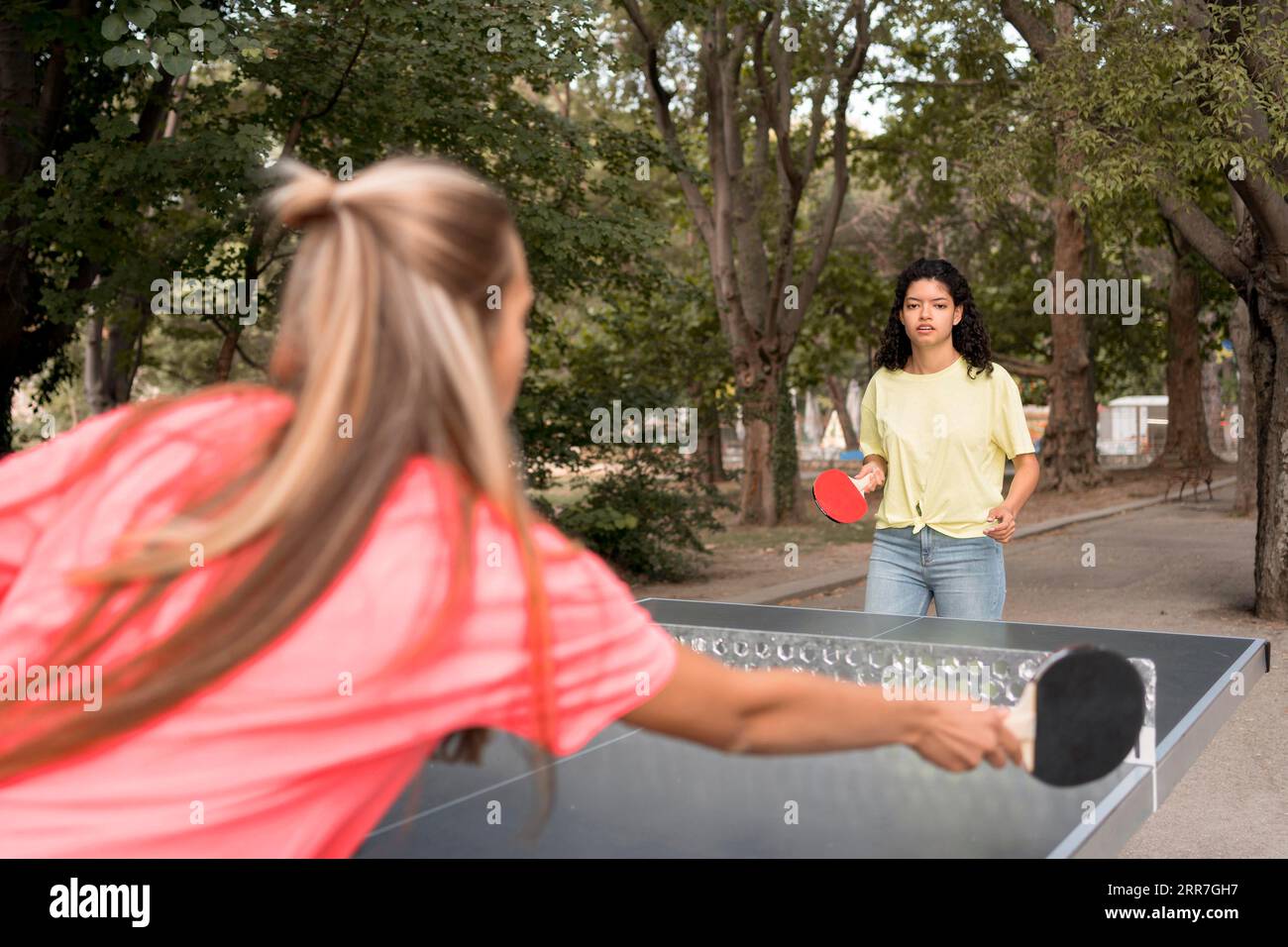 Medium shot girls playing table tennis Stock Photo - Alamy