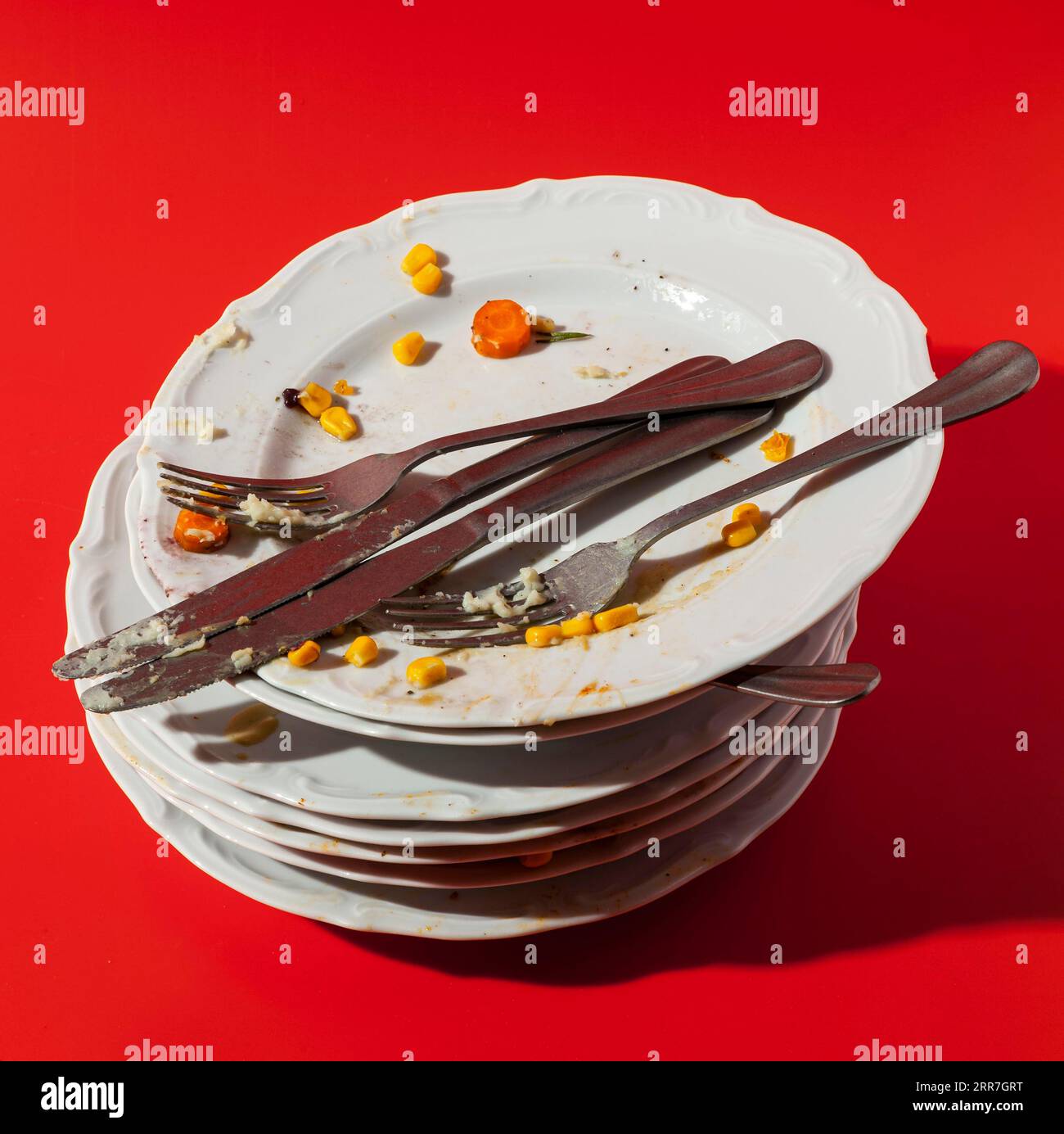 Pile plates with leftovers high view Stock Photo - Alamy