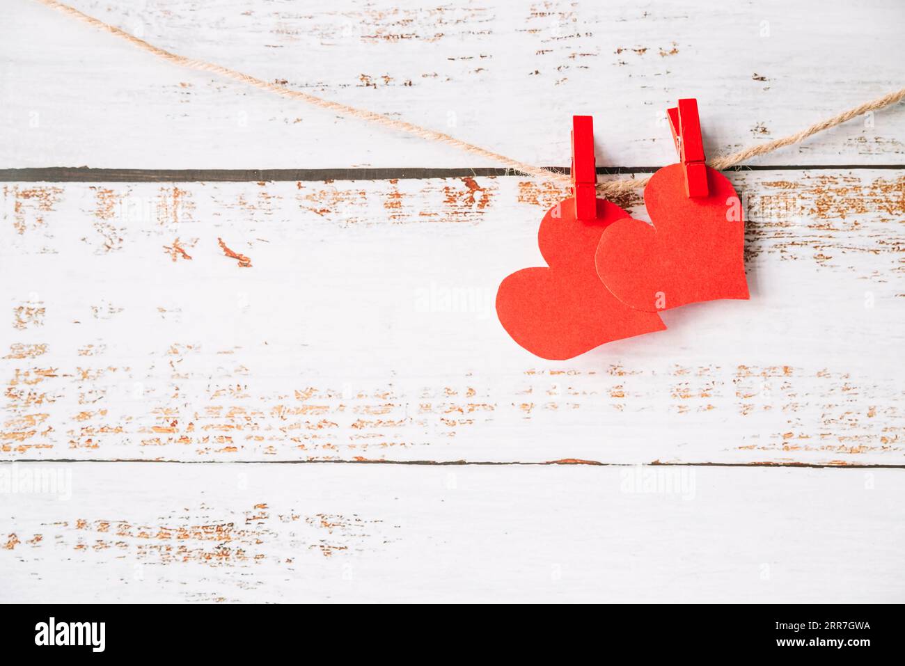 Paper hearts with pins hitching thread Stock Photo - Alamy