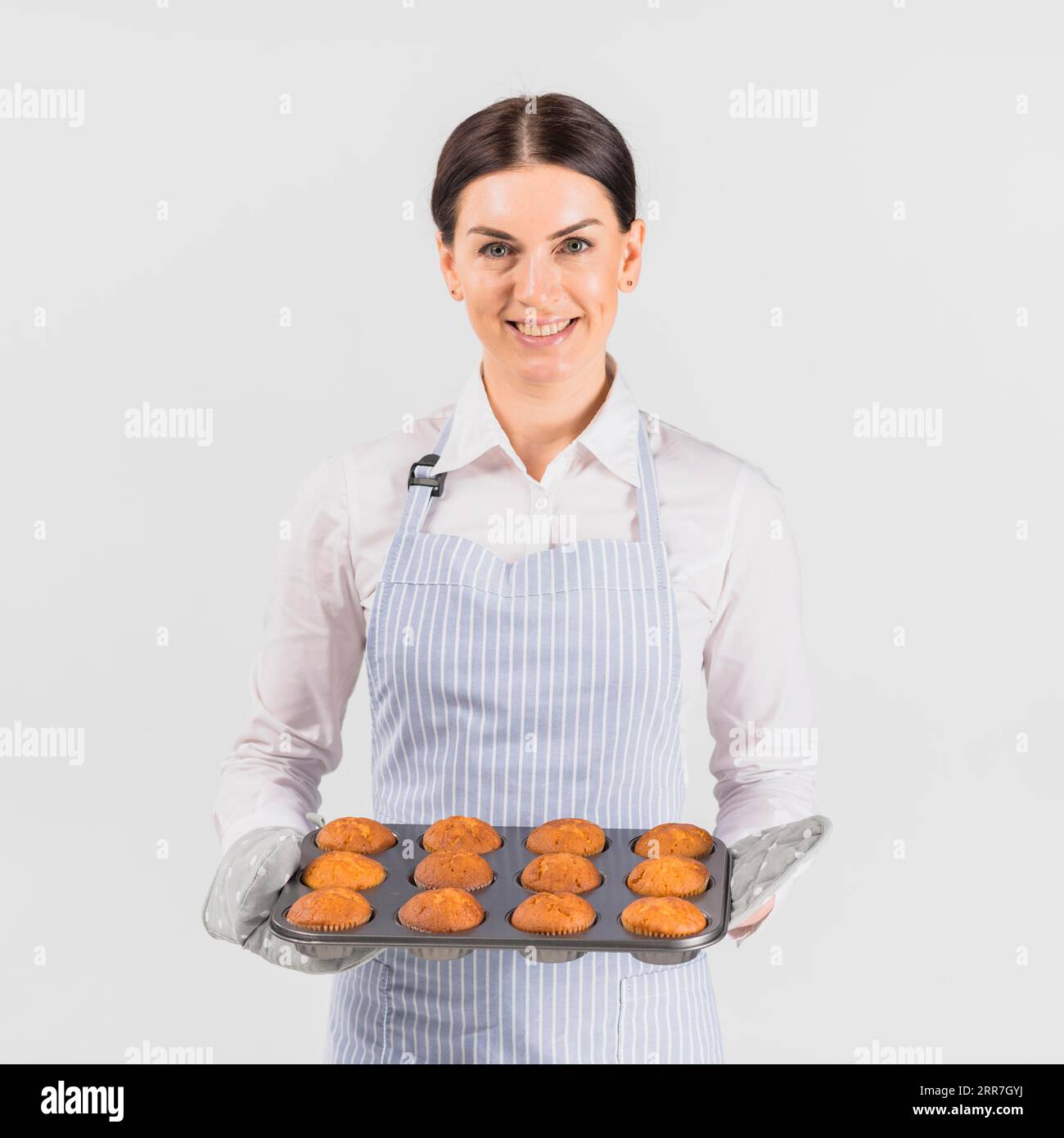 Pastry chef female smiling with muffin tin Stock Photo - Alamy