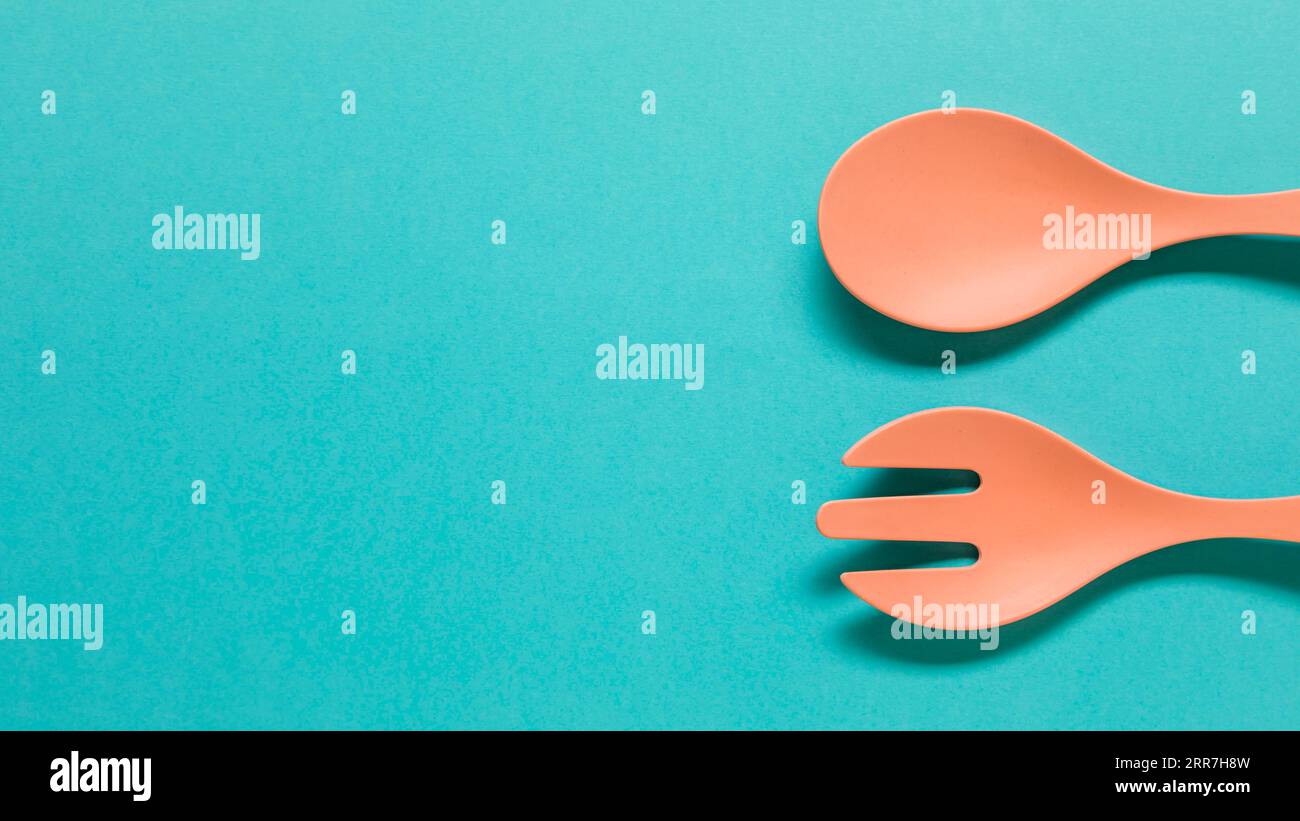 Spoon fork edge blue background Stock Photo - Alamy