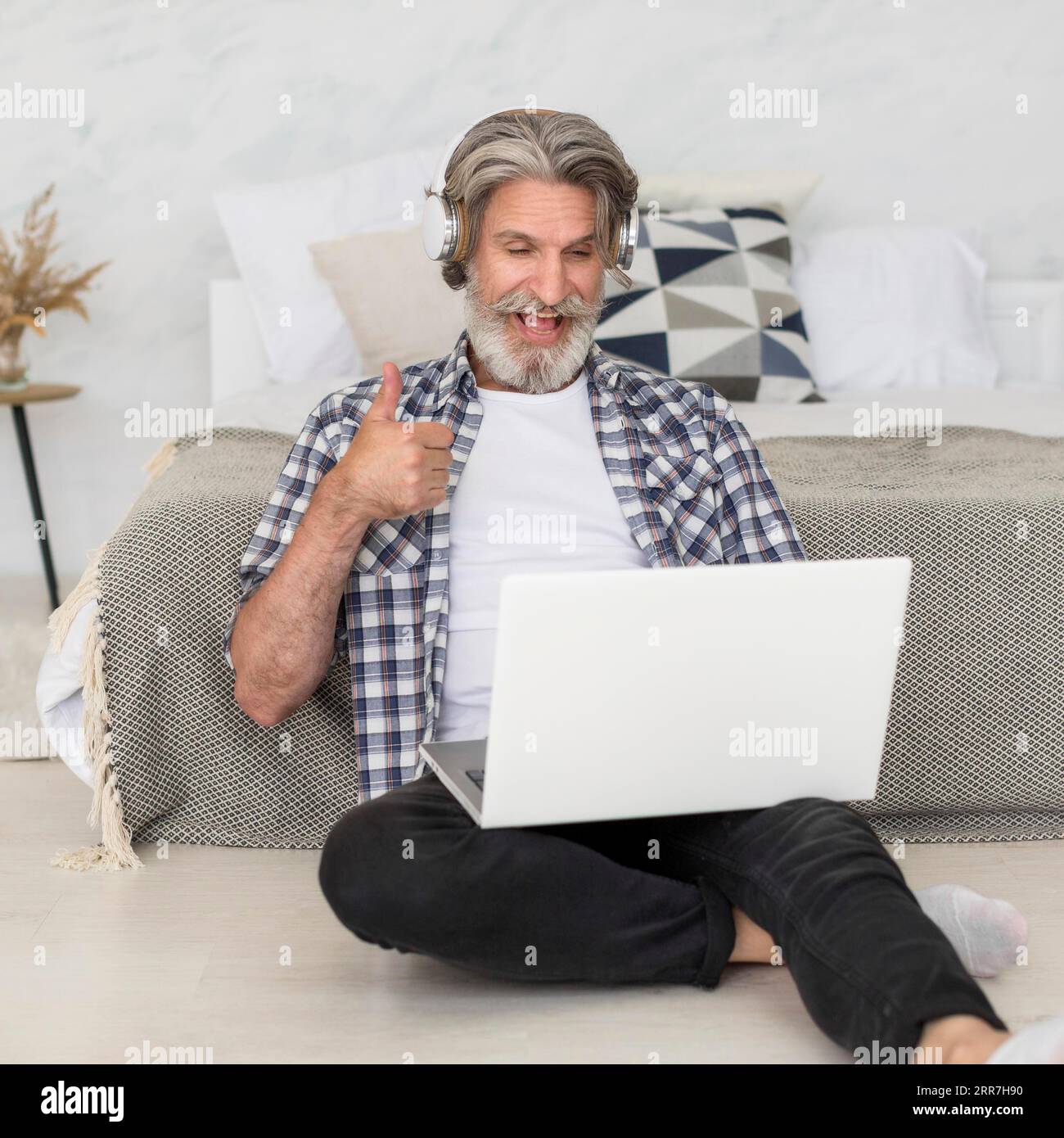 Teacher talking laptop sitting floor Stock Photo - Alamy