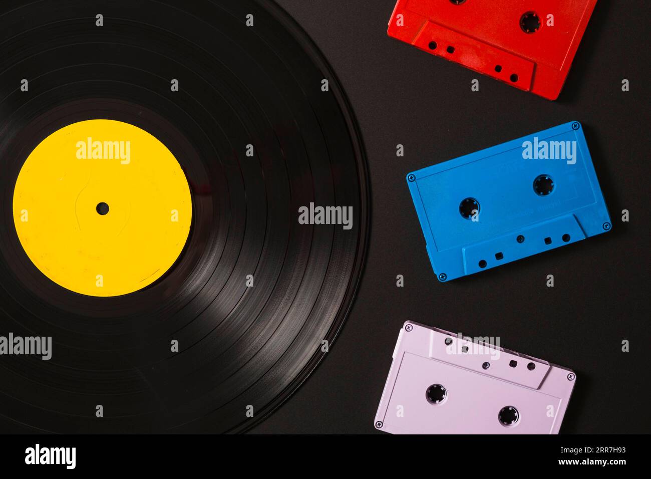 Three cassette tapes vinyl record black background Stock Photo - Alamy