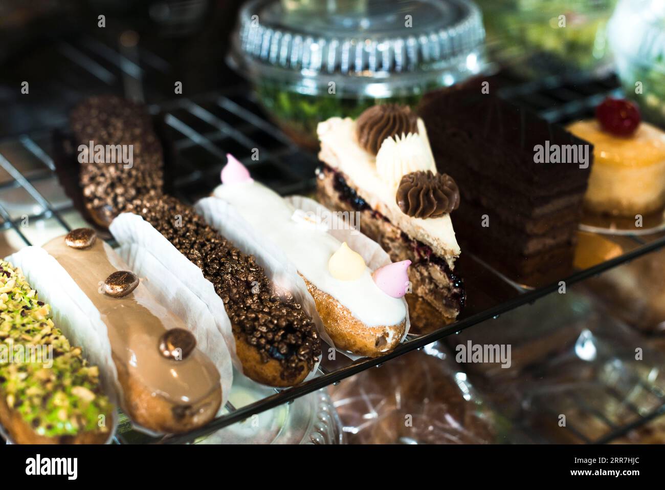 Variety eclairs delicious cake pastries display cabinet Stock Photo - Alamy