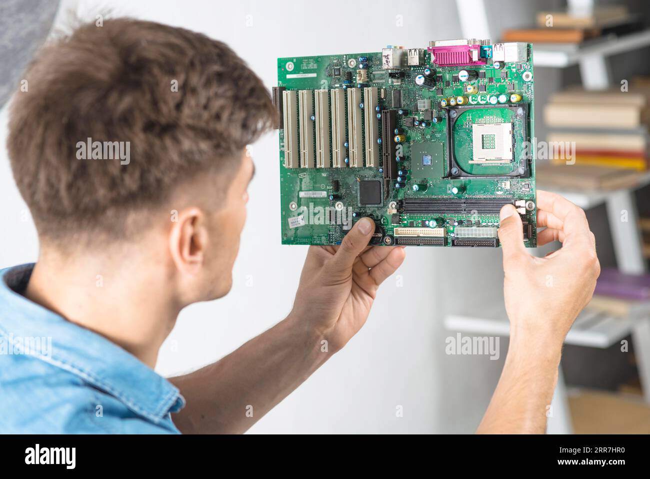 Young it technician looking motherboard Stock Photo - Alamy