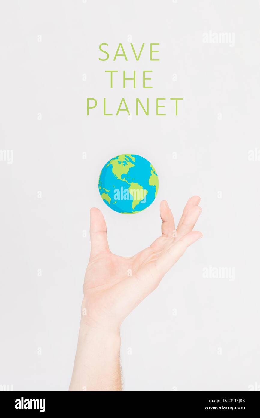 Crop hand holding little earth Stock Photo - Alamy
