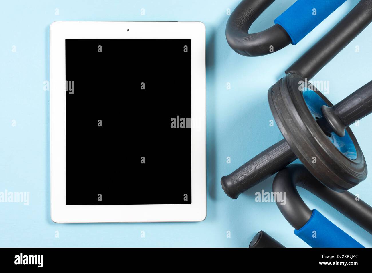 Digital tablet with black display gym equipments blue backdrop Stock ...