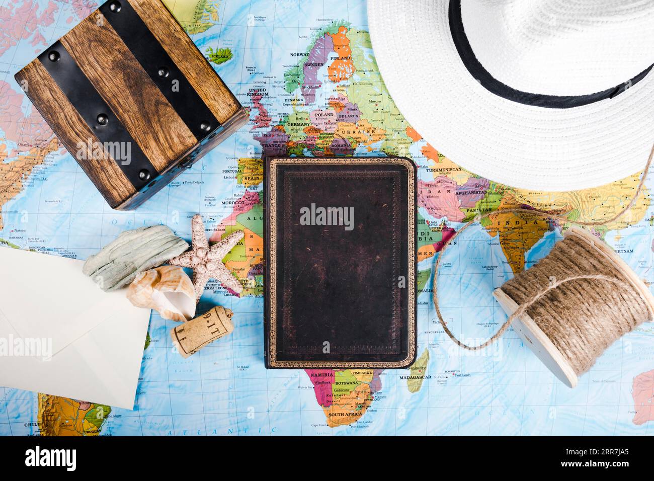 Diary sea shell hat wooden box spool world map Stock Photo - Alamy