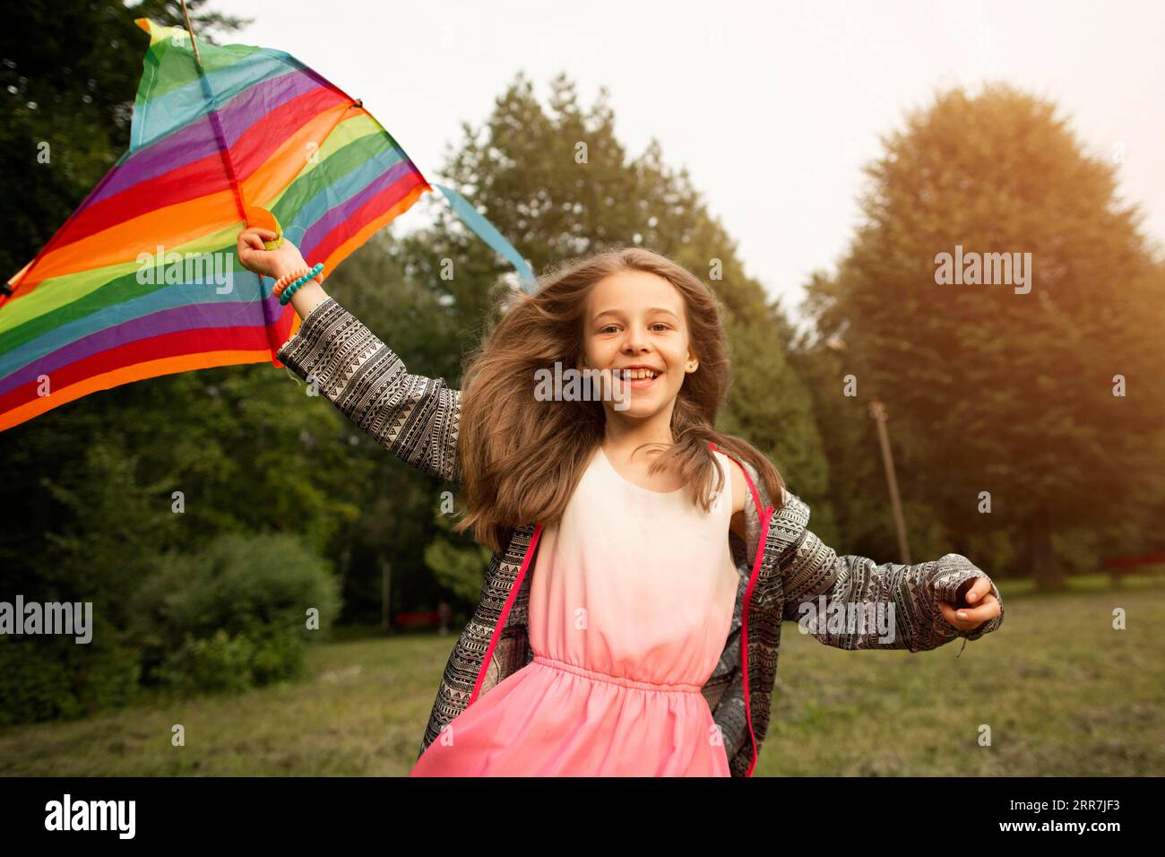 Front view beautiful happy girl with kite Stock Photo - Alamy
