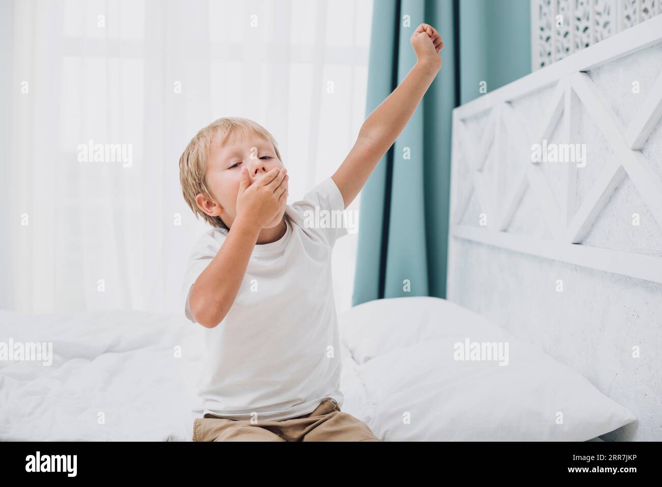 Little boy yawning after waking up Stock Photo - Alamy