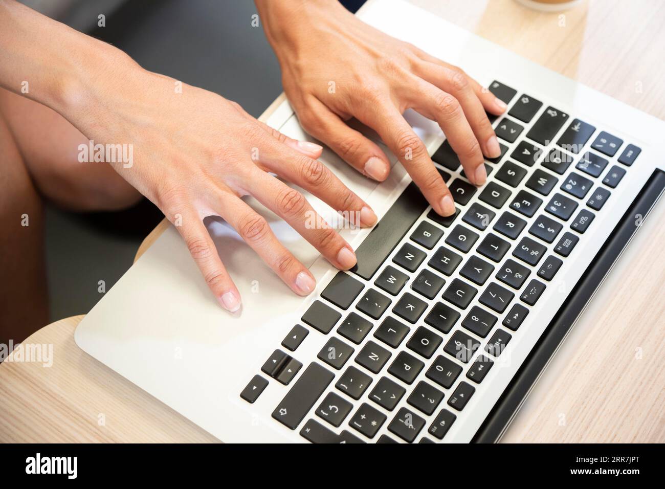 Hand typing laptop top view Stock Photo - Alamy