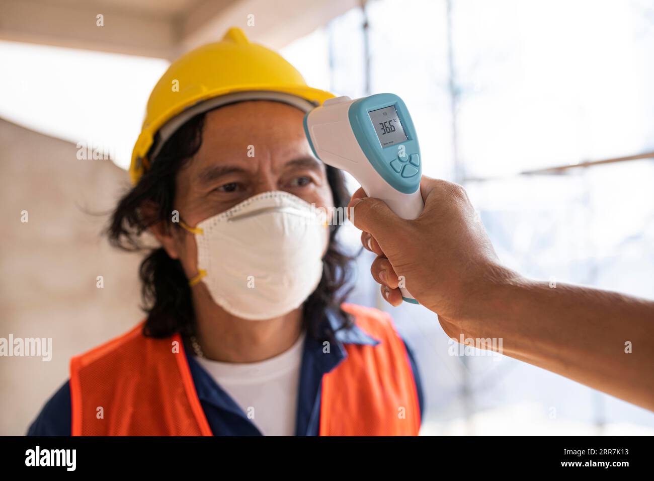 Measuring employee temperature Stock Photo - Alamy
