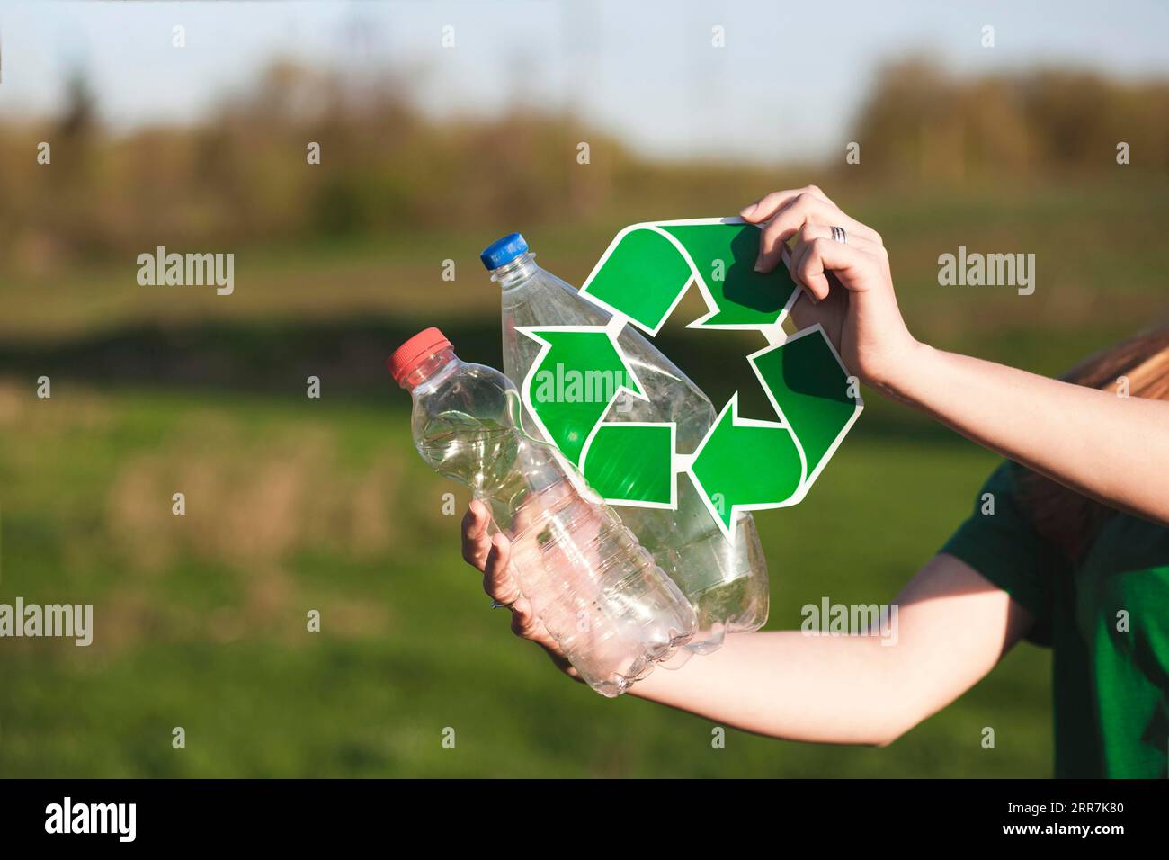Recycle background with woman holding recycle sign Stock Photo - Alamy