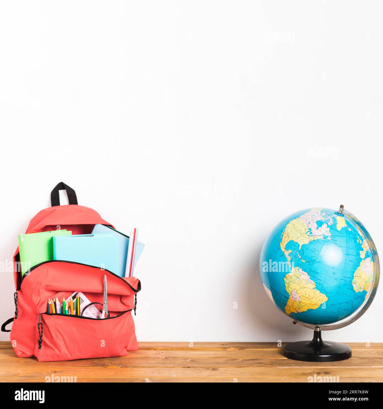 School bag with globe table Stock Photo - Alamy