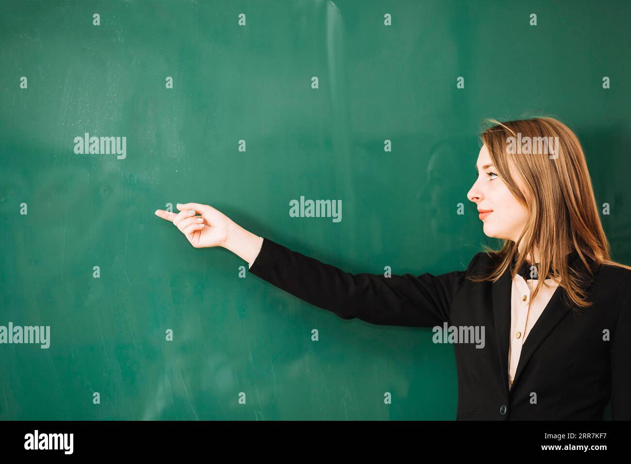 Teacher pointing finger board Stock Photo - Alamy