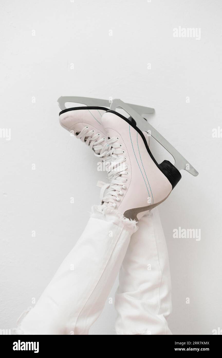 Woman wearing white ice skates Stock Photo - Alamy