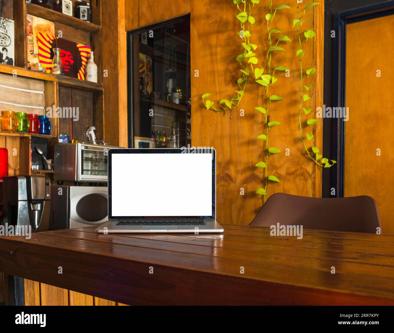 White blank screen laptop dining table home Stock Photo - Alamy