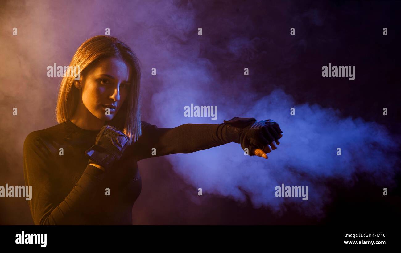 Confident female boxer looking camera Stock Photo - Alamy