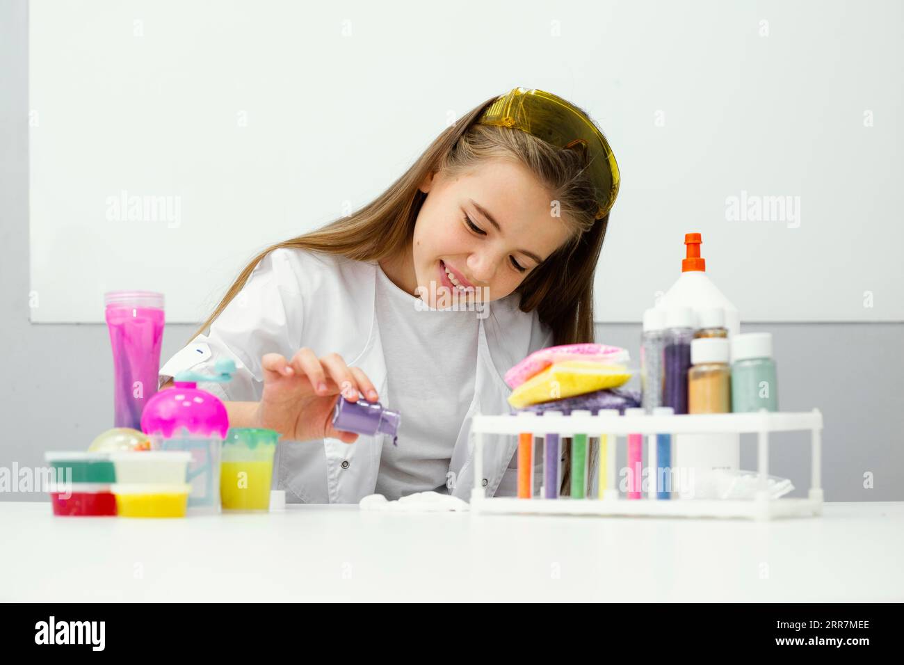 Front view young girl scientist experimenting with slime colors Stock ...