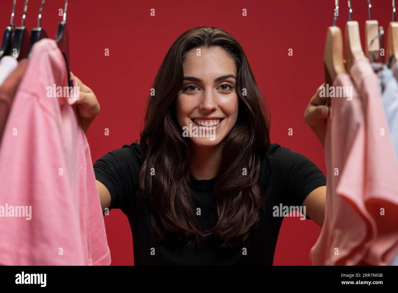 Front view woman looking through clothes Stock Photo - Alamy