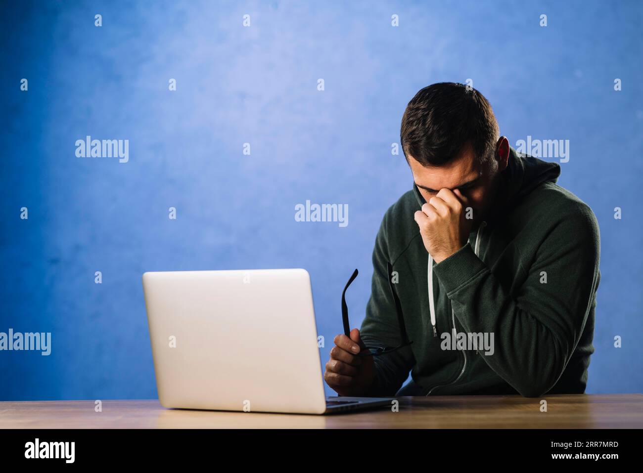Hacker with desperate tired expression Stock Photo - Alamy