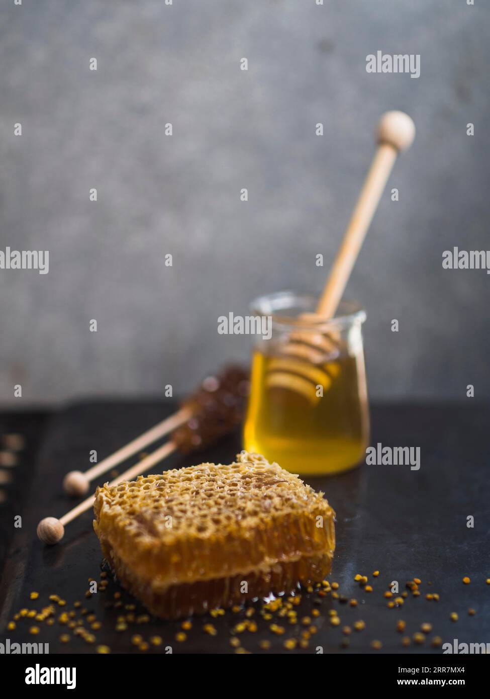Honey comb with honey wooden dipper bee pollen Stock Photo - Alamy